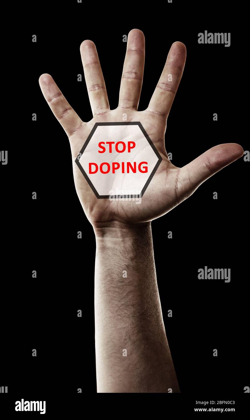 Stop doping concept. Male hand with sign isolated on black Stock Photo ...