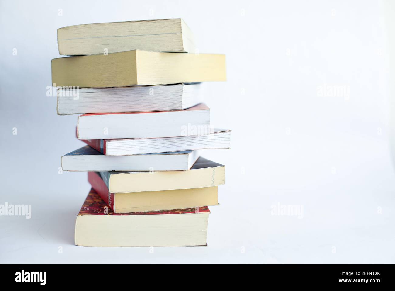 Close up of books pyramid on the white background Stock Photo - Alamy