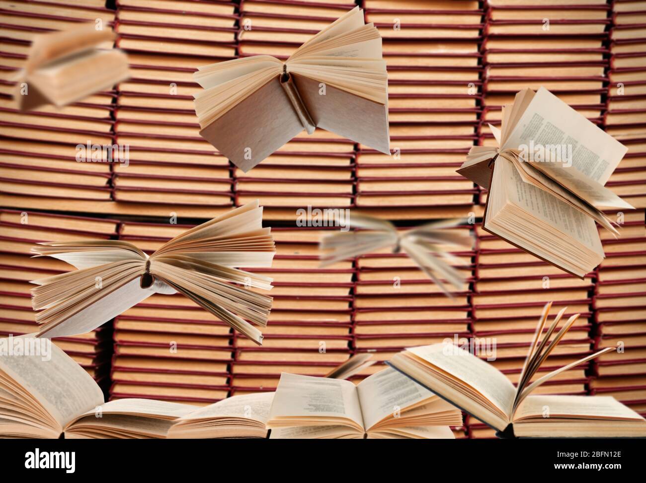 Flying open books in library Stock Photo - Alamy