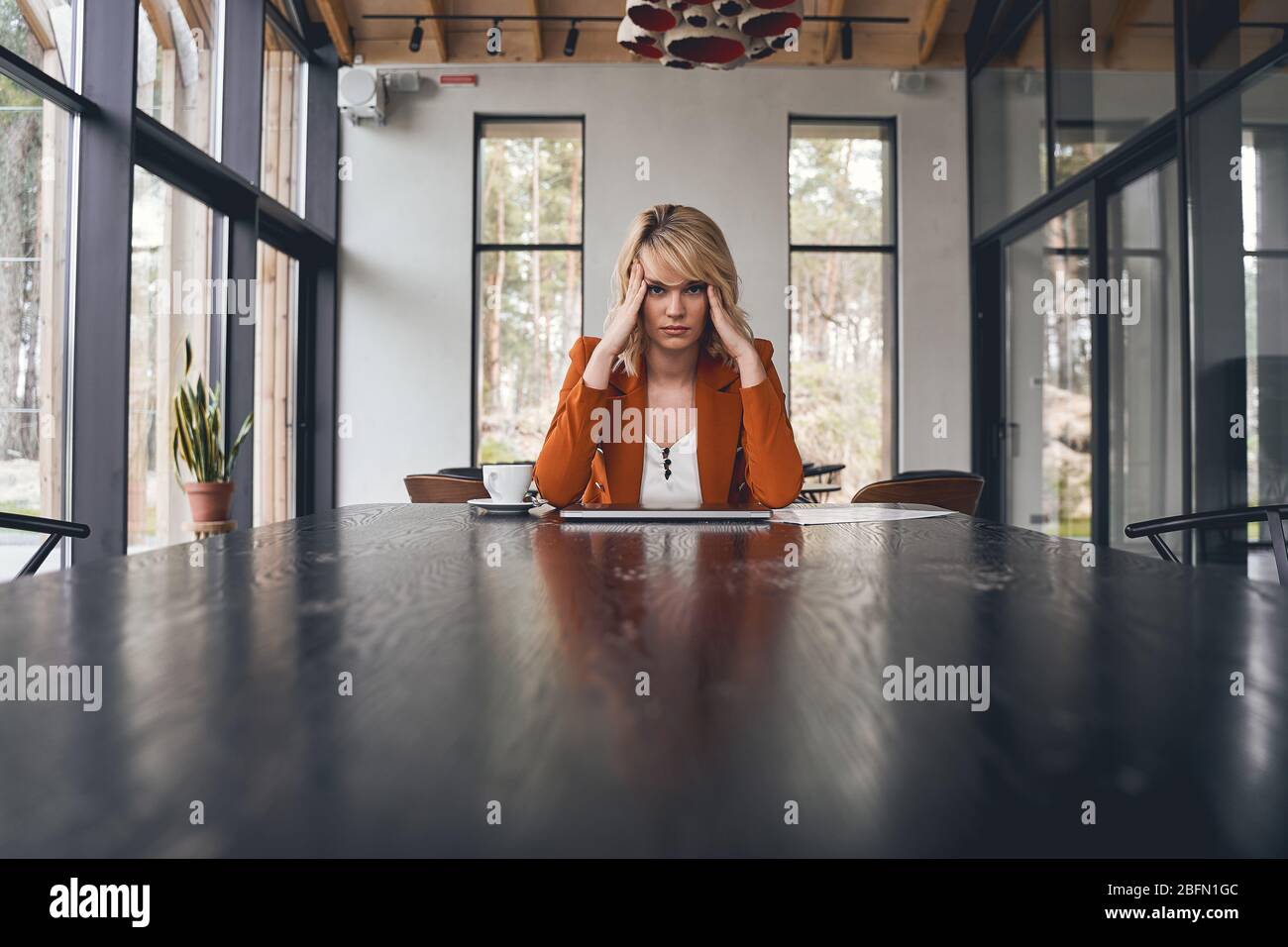 Sad elegant Caucasian business lady looking forward Stock Photo - Alamy
