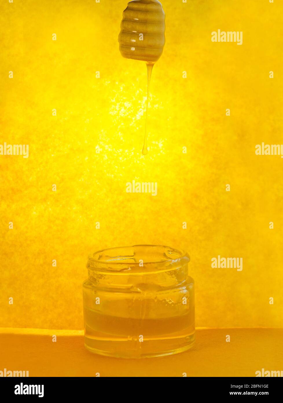 Organic sweet honey splashes. Honey dripping with honey dipper. Honey ...