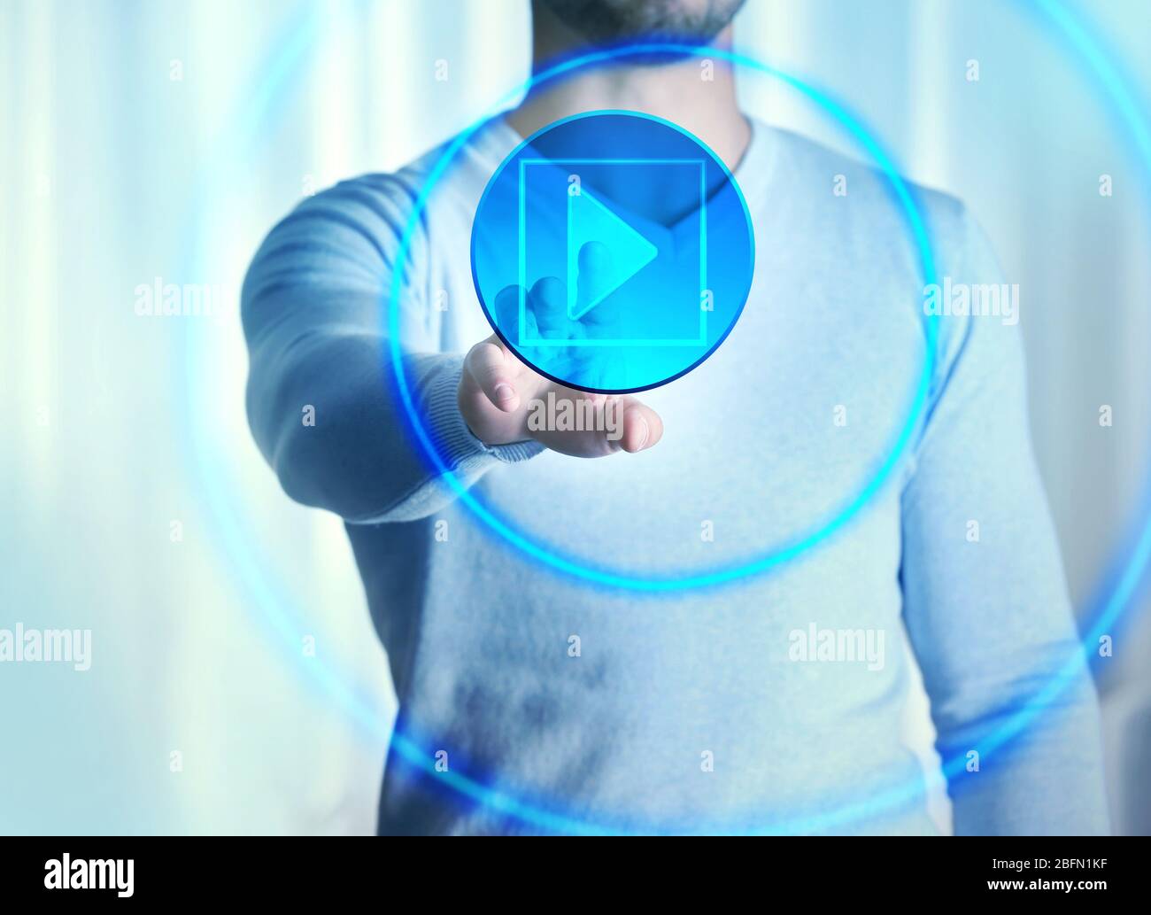 Man push play button on touch screen Stock Photo - Alamy