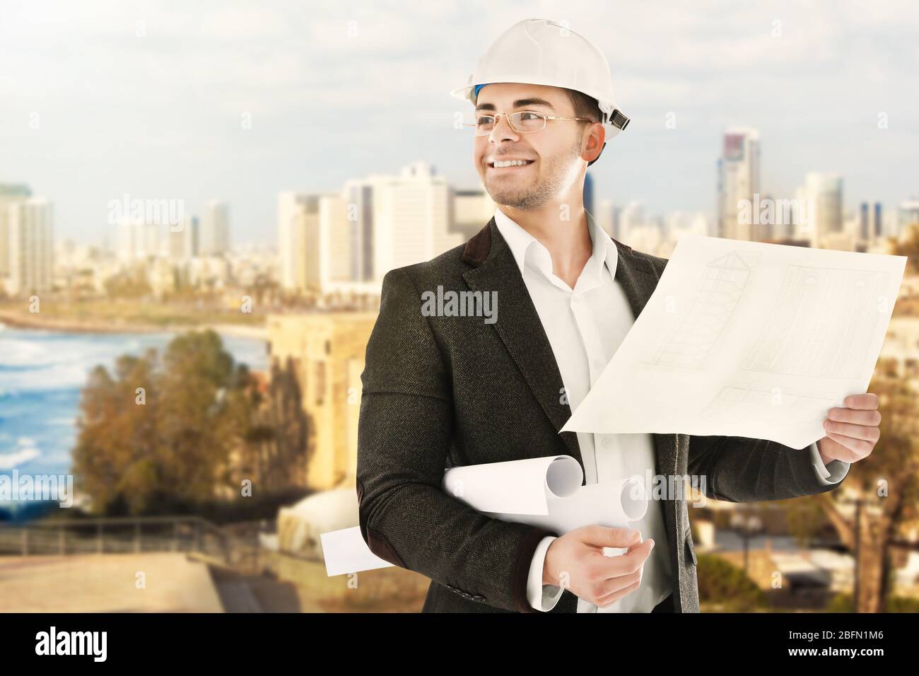 Architect in hardhat on blurred urban background Stock Photo - Alamy