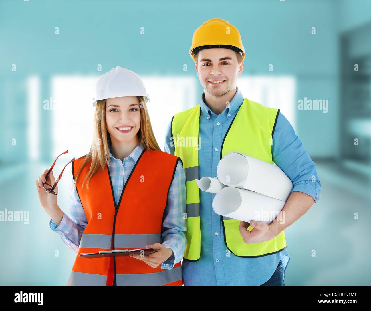Two architects at work on blurred background Stock Photo - Alamy