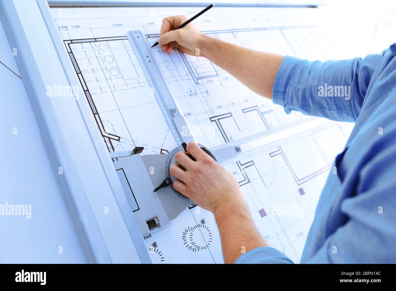 Male architects working on blueprints Stock Photo - Alamy