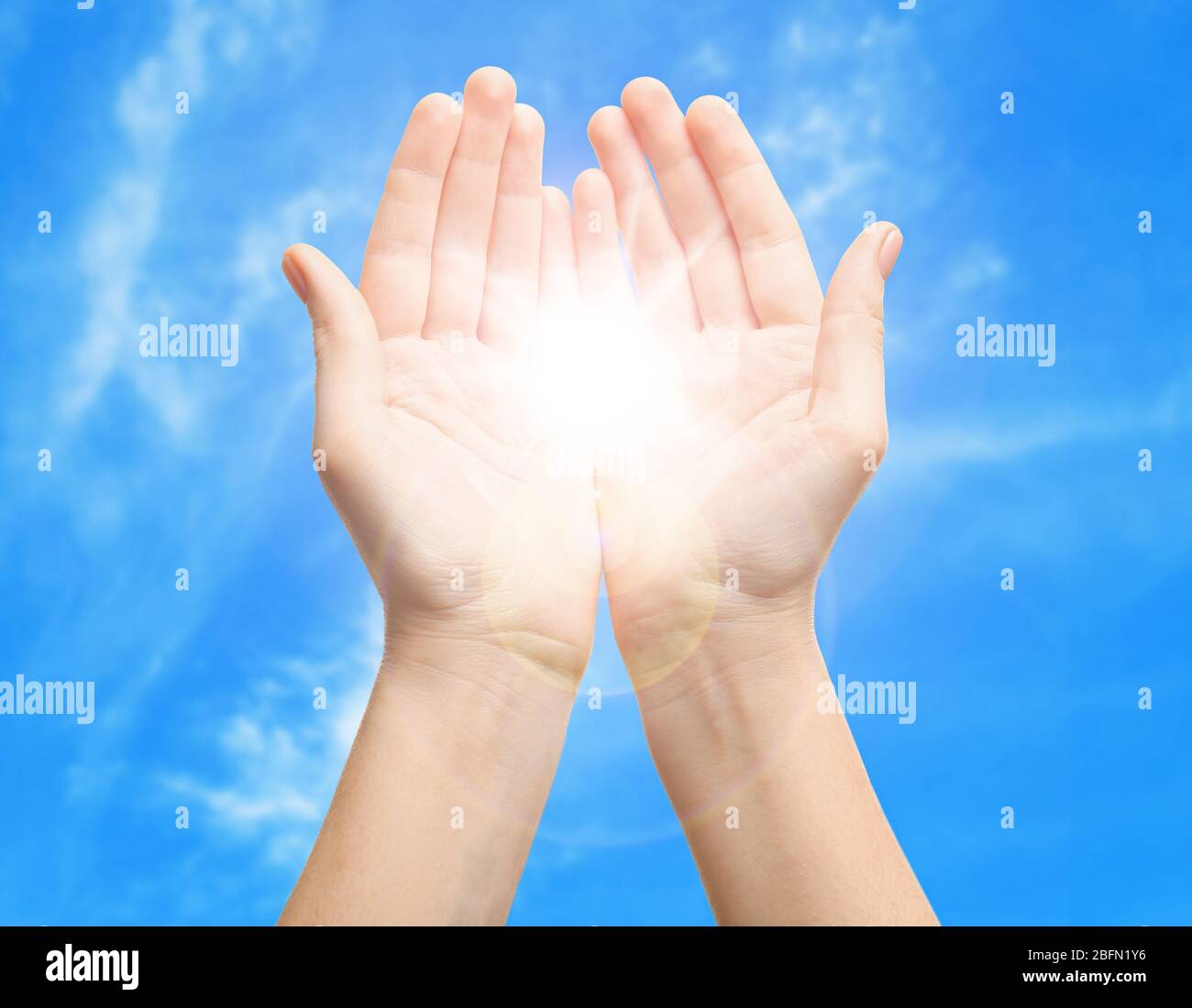 Female hands with sun Stock Photo - Alamy