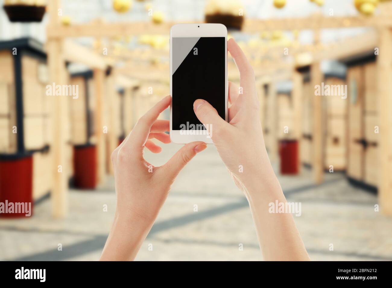 Female hands shows mobile smart phone, blurred background Stock Photo ...