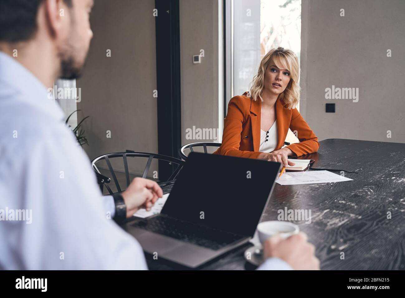Beautiful stylish lady staring at her male boss Stock Photo - Alamy