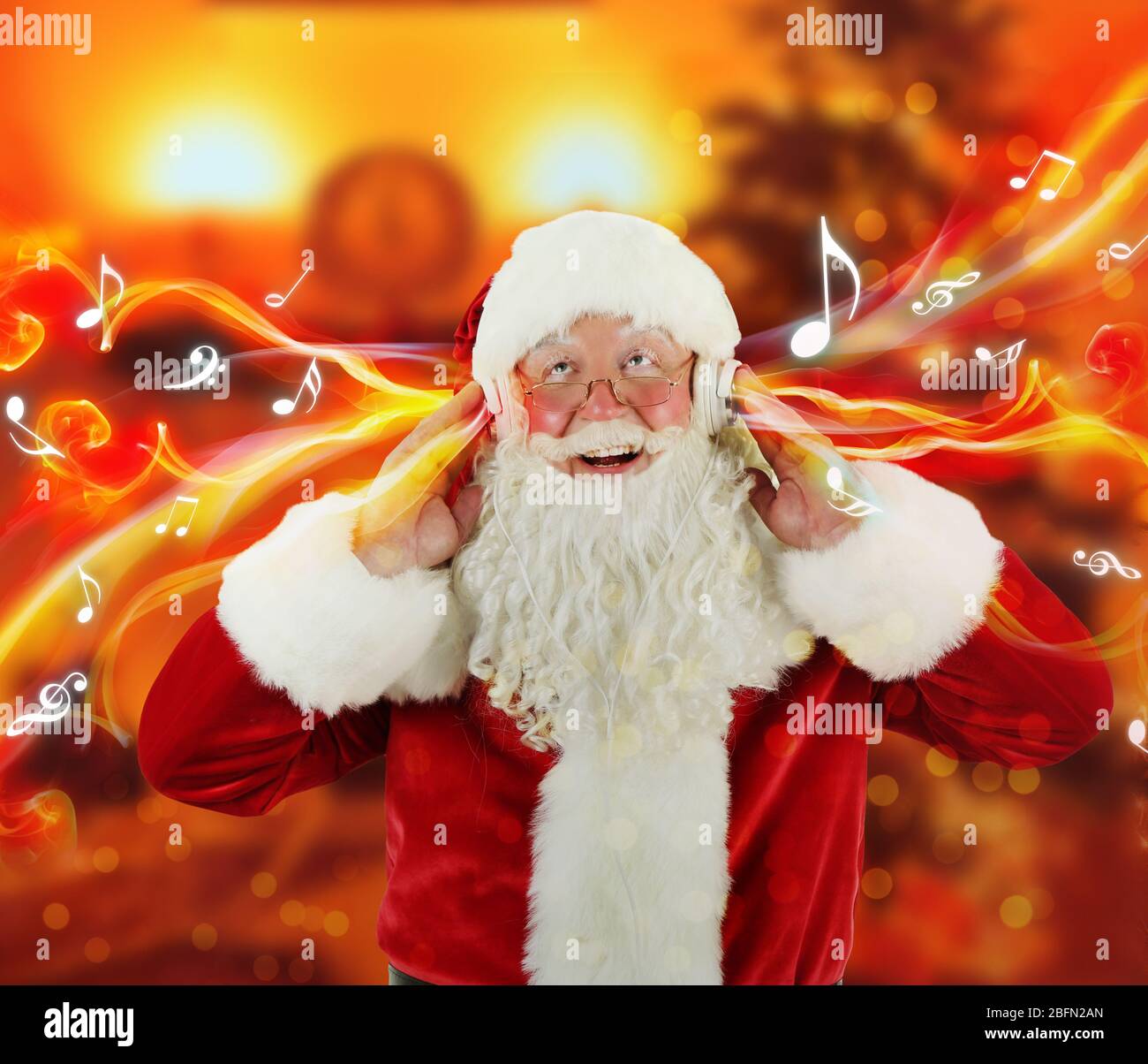 Santa Claus with headphones listening to music against bright ...