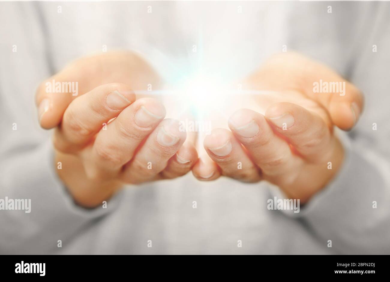 Light in hands. Concept of taking, care, protection Stock Photo - Alamy
