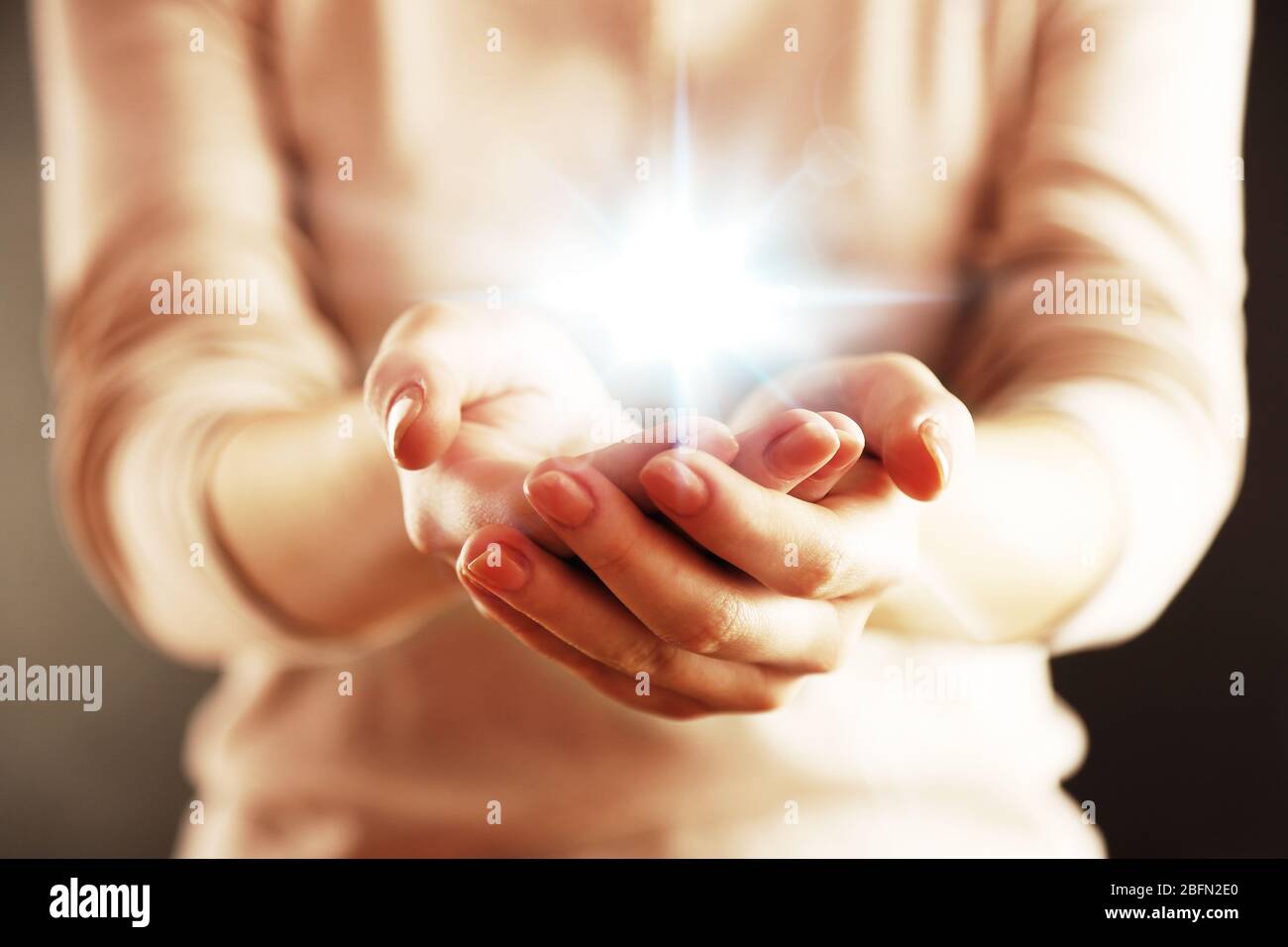 Light in hands. Concept of taking, care, protection Stock Photo - Alamy