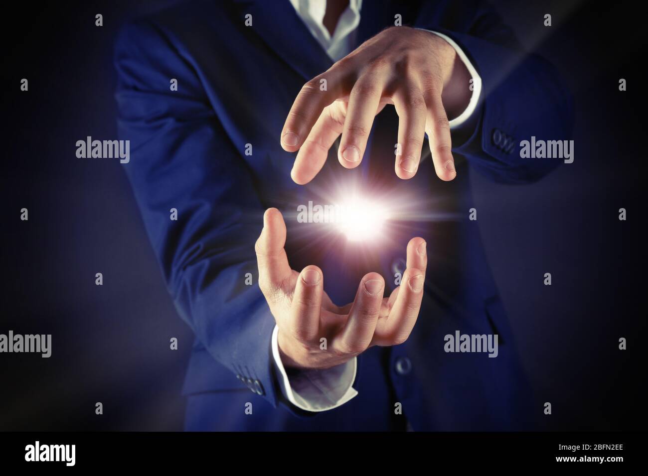 Conceptual open hands glow light hi-res stock photography and images ...