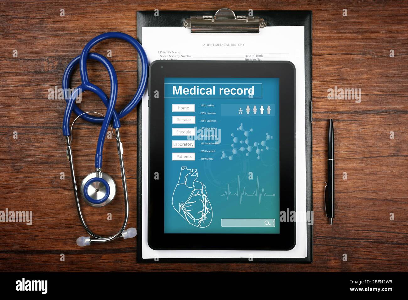 Medical record on tablet screen with stethoscope on wooden background ...