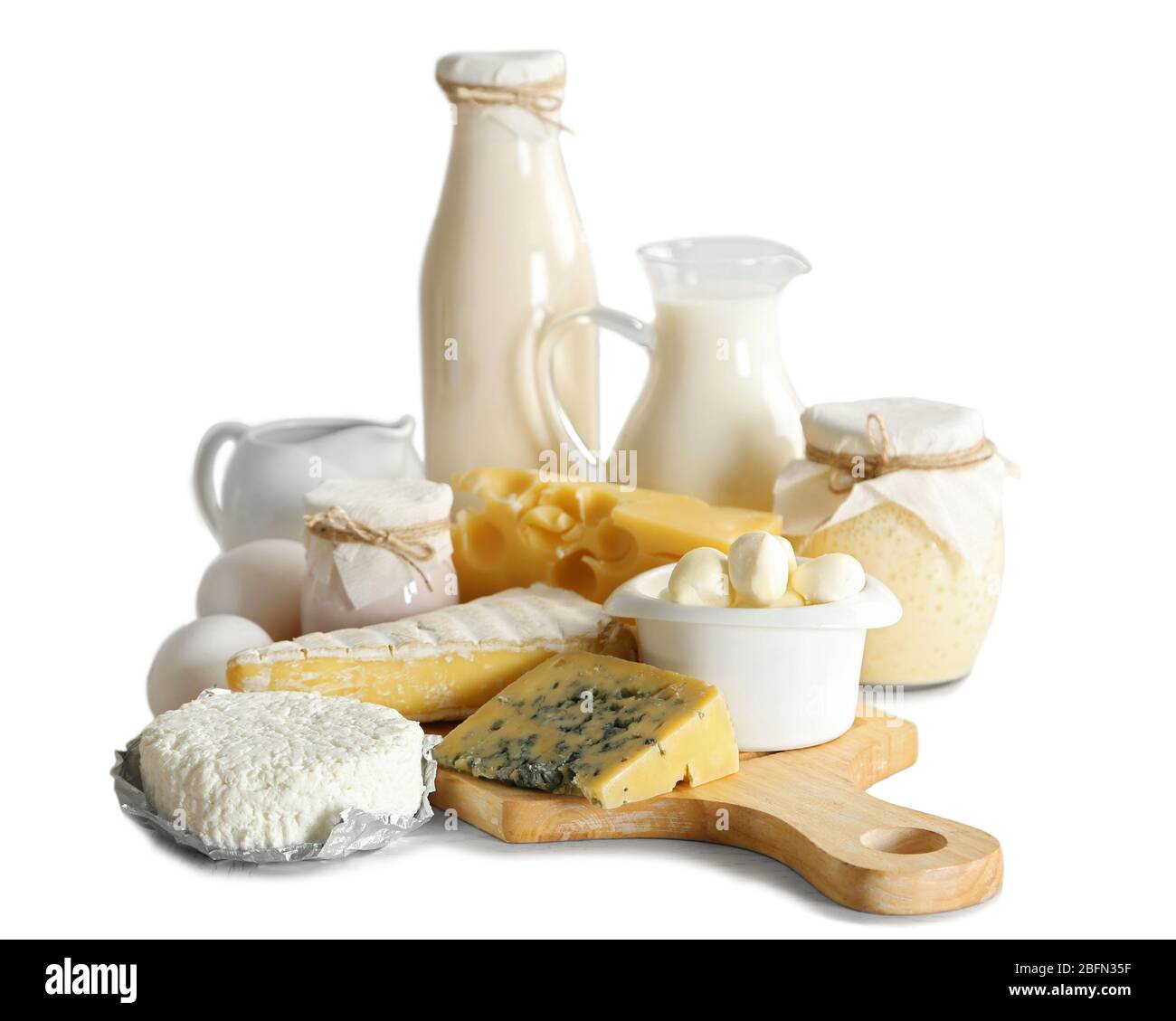 Set of fresh dairy products on wooden board, isolated on white Stock ...