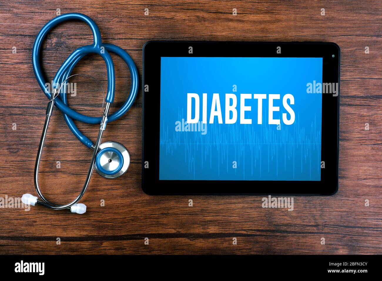 Tablet and text Diabetes on screen on wooden background Stock Photo - Alamy