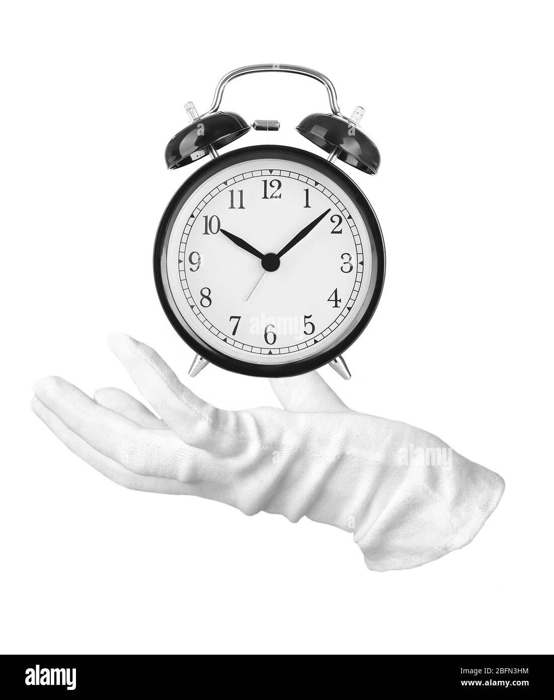 Hand in white glove holding old alarm clock isolated on white Stock ...