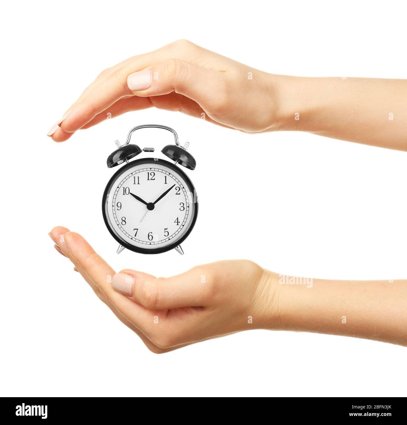 Female hands holding a clock isolated on white Stock Photo - Alamy