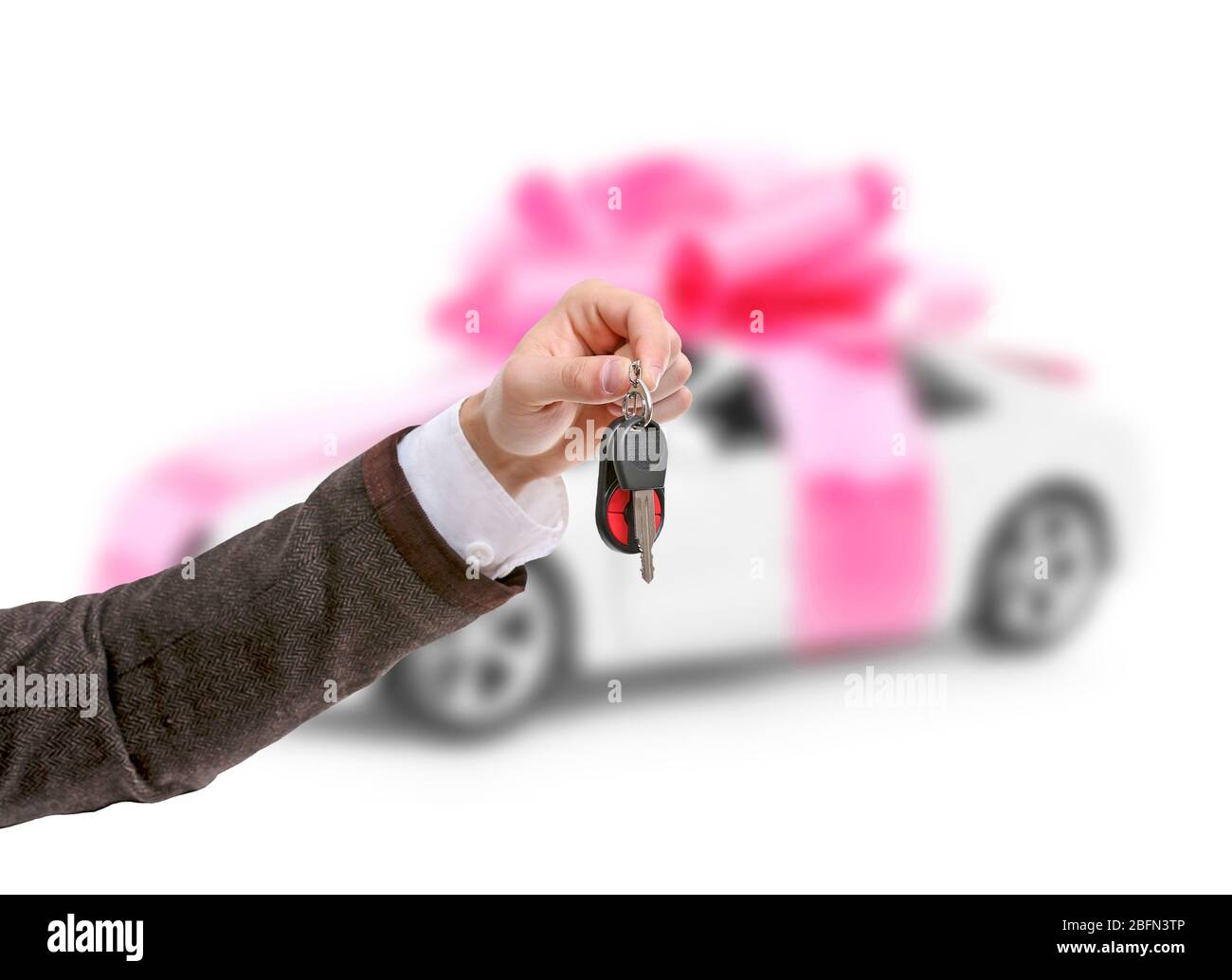 Male hand holding car keys against car background Stock Photo - Alamy