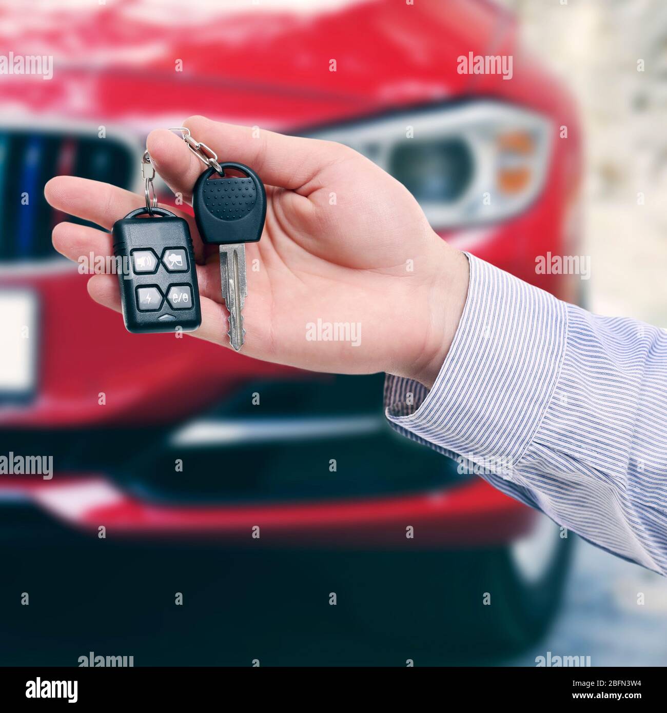 Male hand holding car keys on car background Stock Photo - Alamy