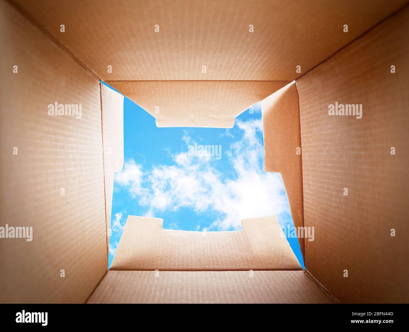 Looking on blue sky. Thinking outside the box concept Stock Photo - Alamy