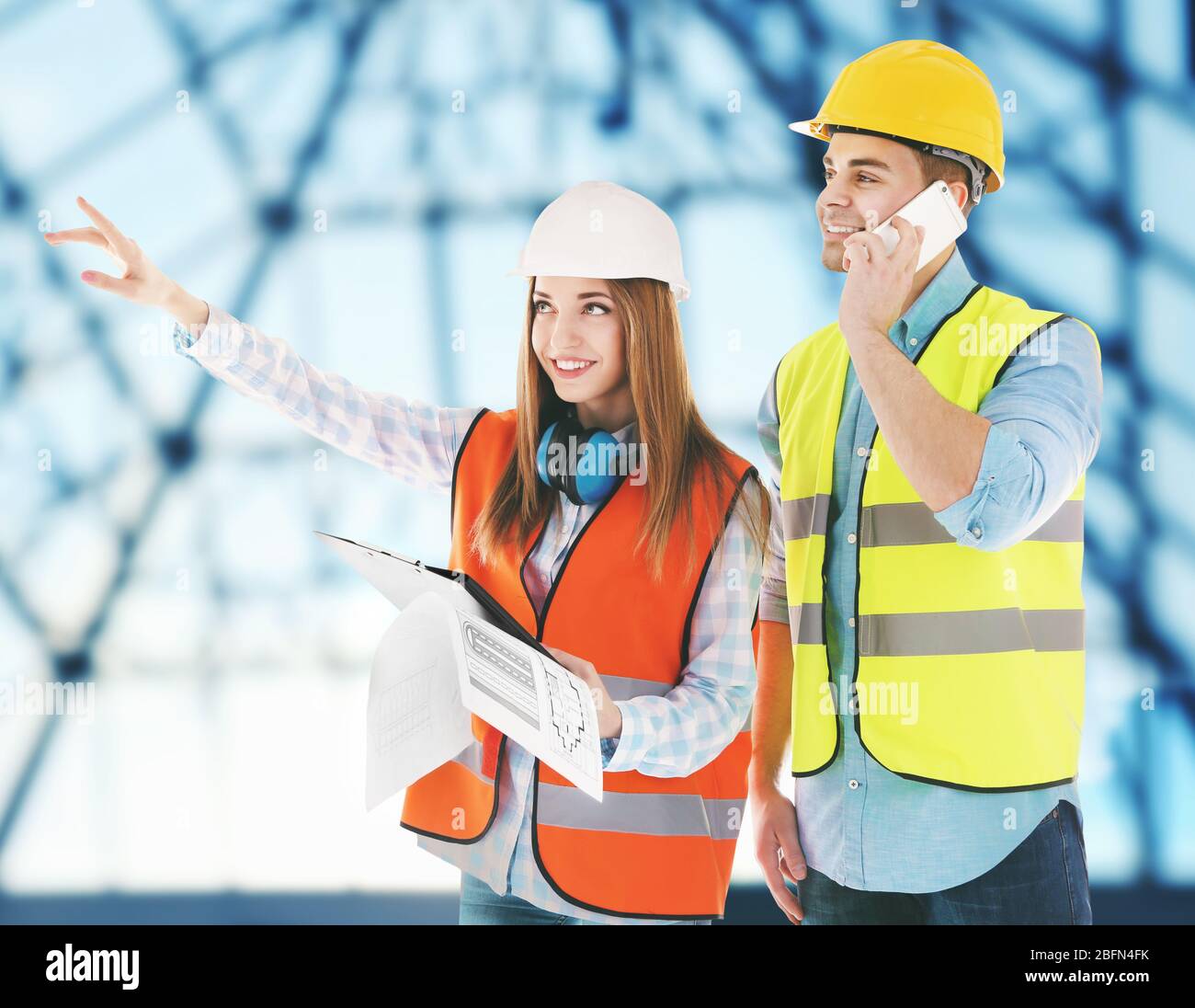 Two architects at work on blurred construction background Stock Photo ...