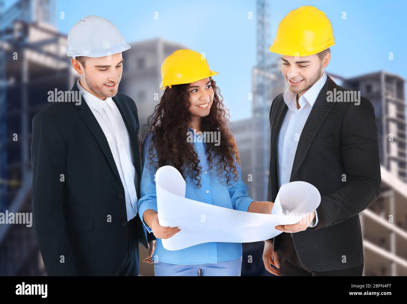 Three architects at work on blurred urban background Stock Photo - Alamy