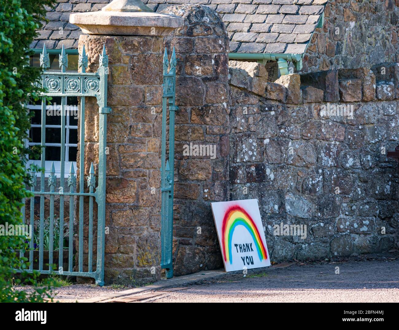 Rainbow drawing symbolising hope and thank you to NHS at entrance gate ...