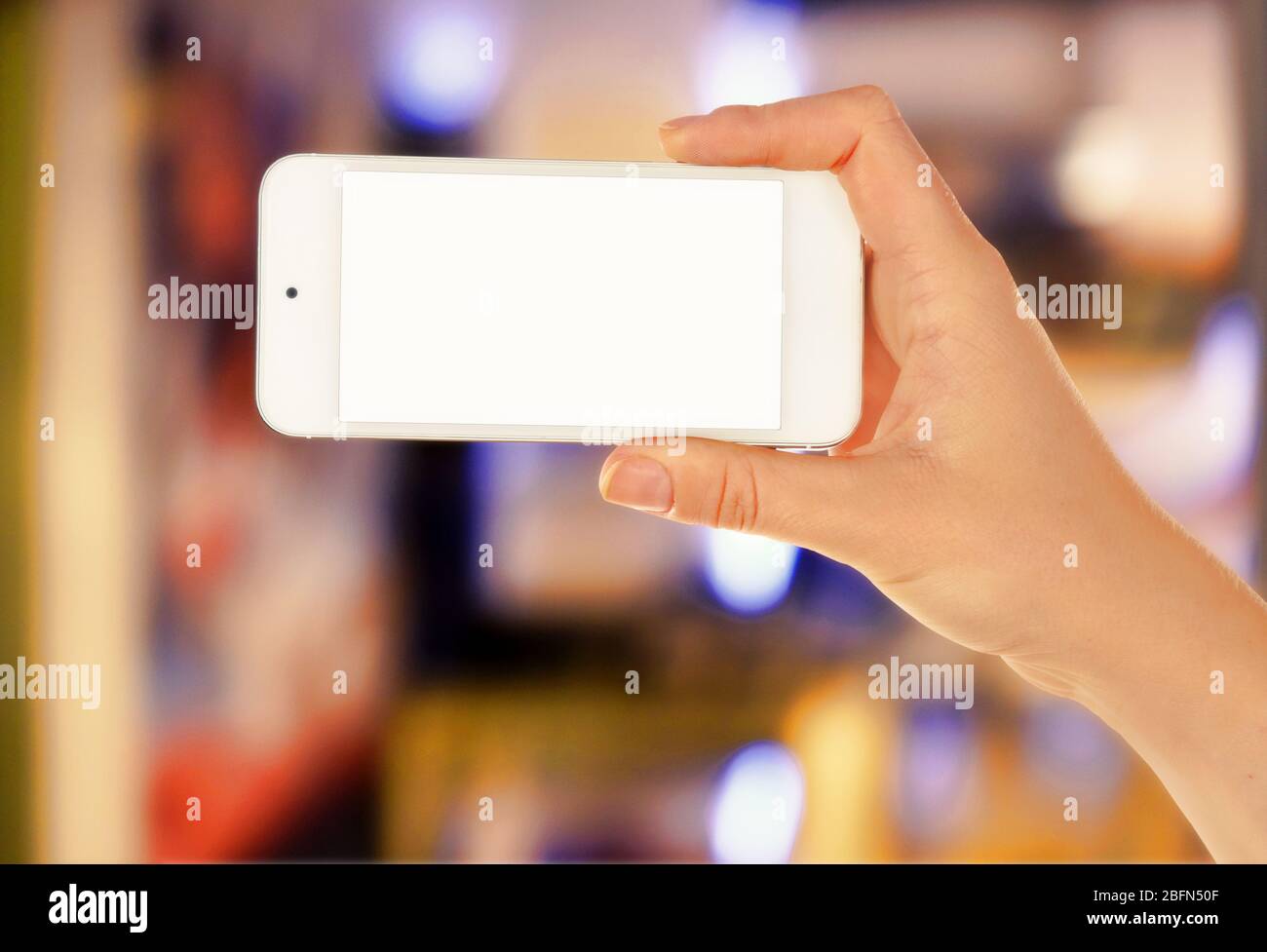 Female hand shows mobile smart phone, blurred background Stock Photo ...