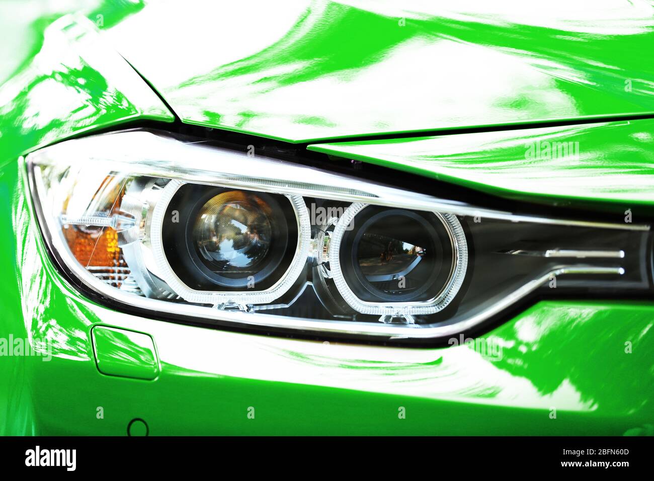 Headlights of green car Stock Photo - Alamy
