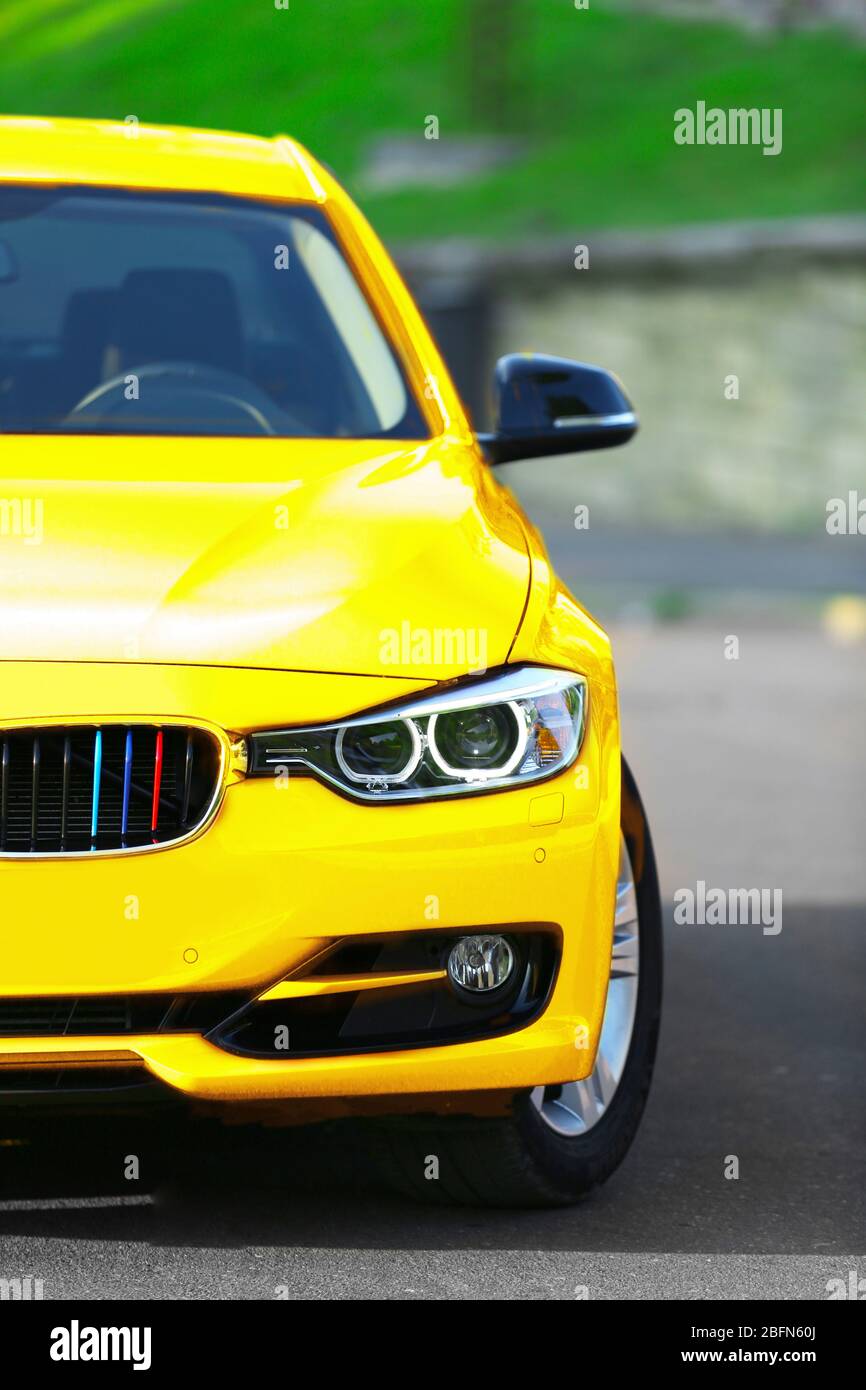 Yellow car on road Stock Photo - Alamy