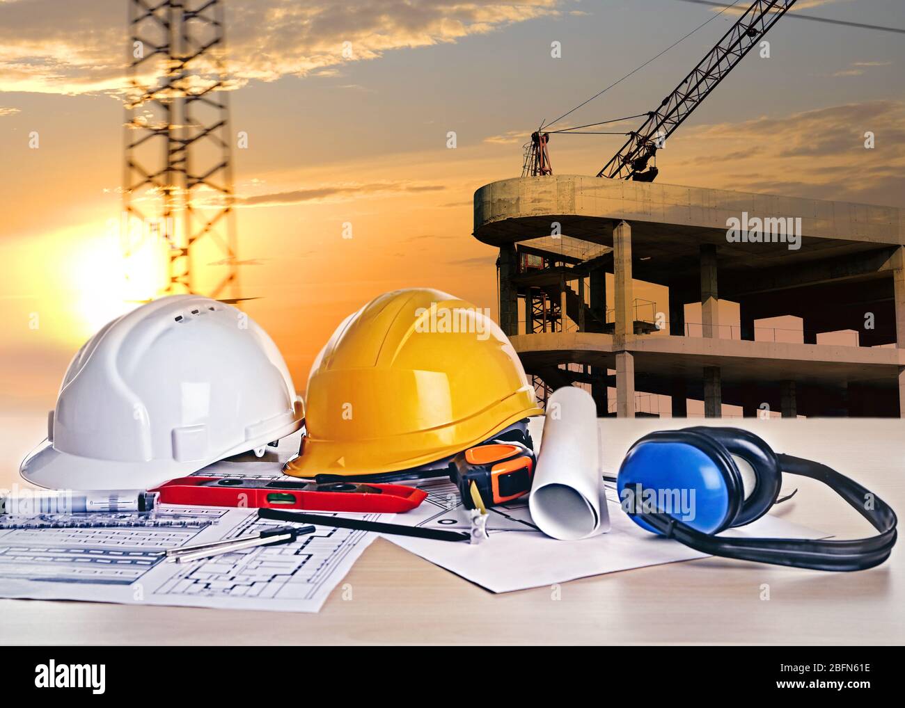 Table with construction drawings and other tools on unfinished building ...
