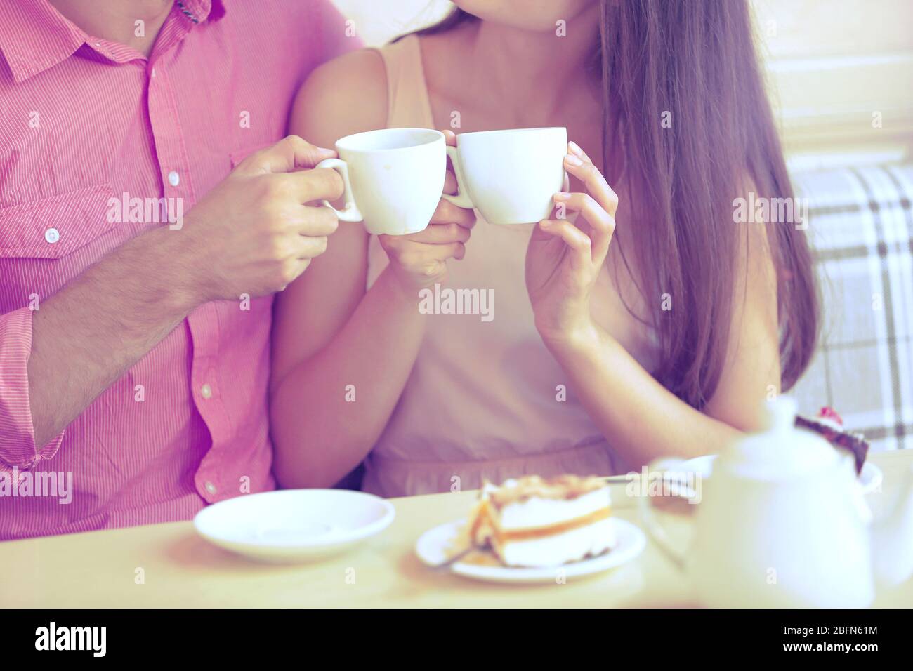 Young couple drinking tea in cafe Stock Photo - Alamy