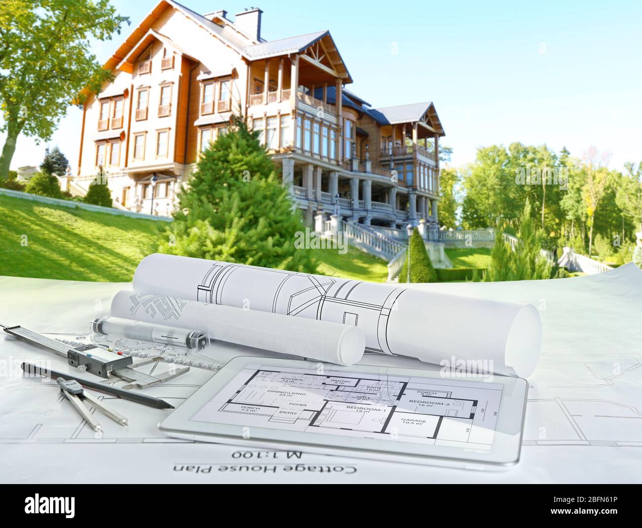 Table with construction drawings and other tools on building background ...
