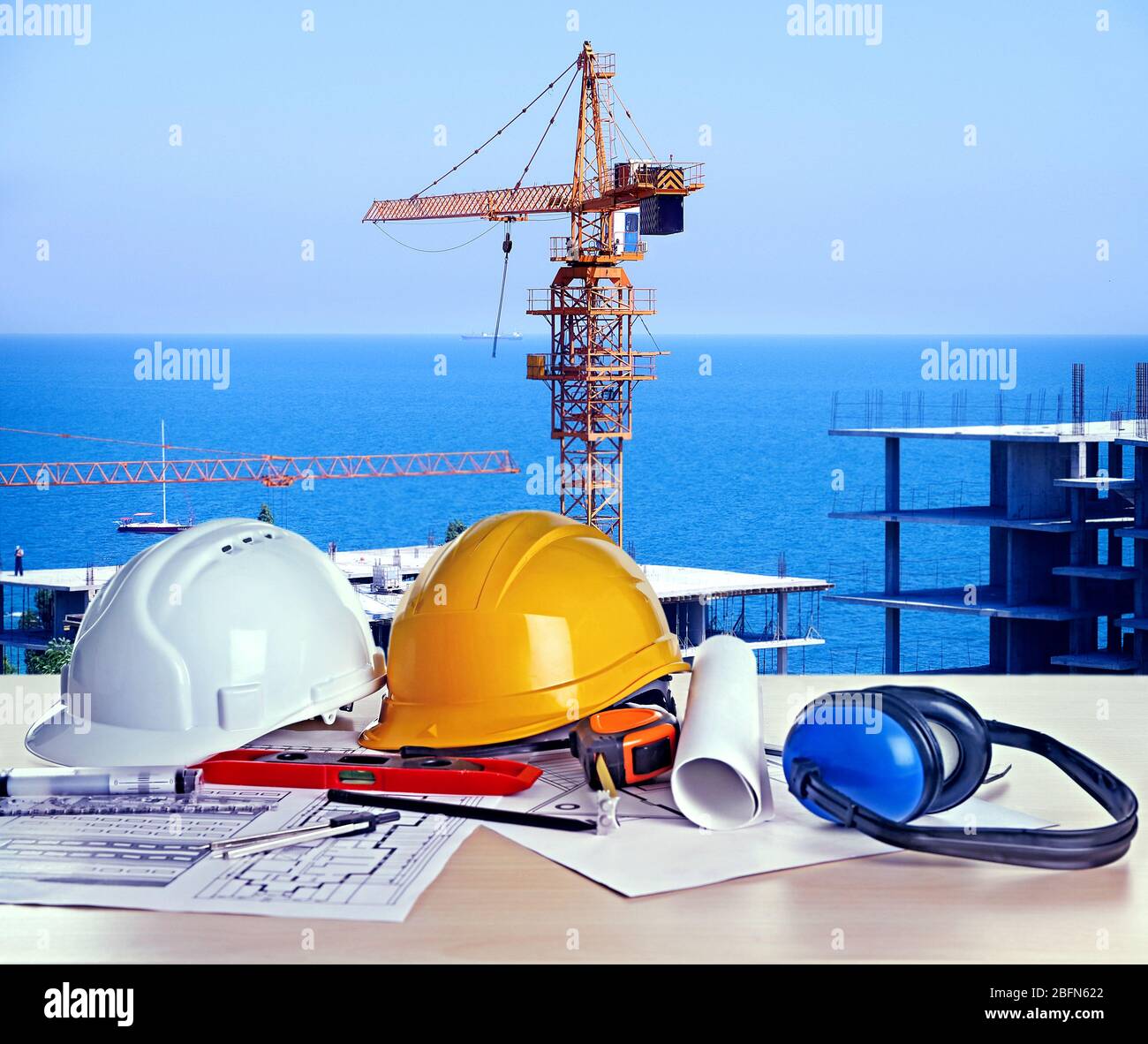 Table with construction drawings and other tools on construction ...