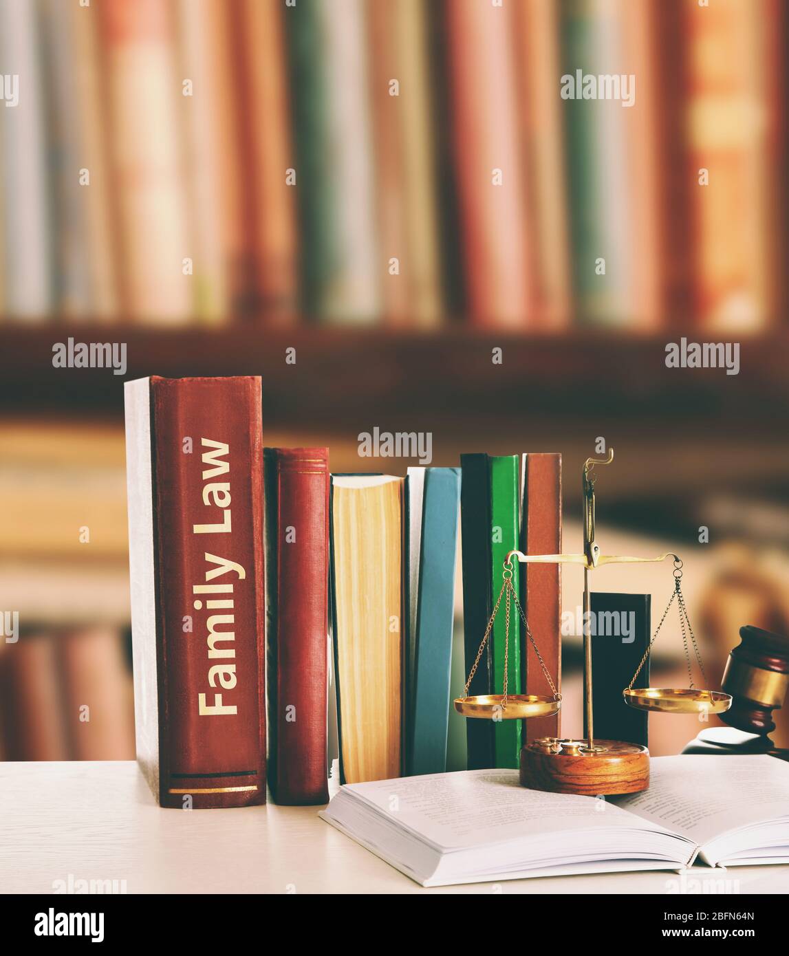 Wooden gavel with justice scales on table in library Stock Photo - Alamy