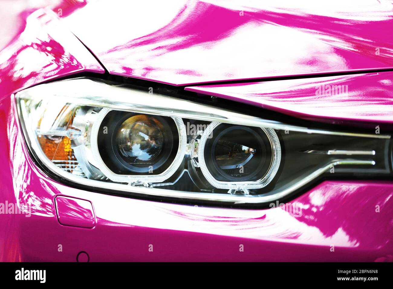 Headlights of pink car Stock Photo - Alamy