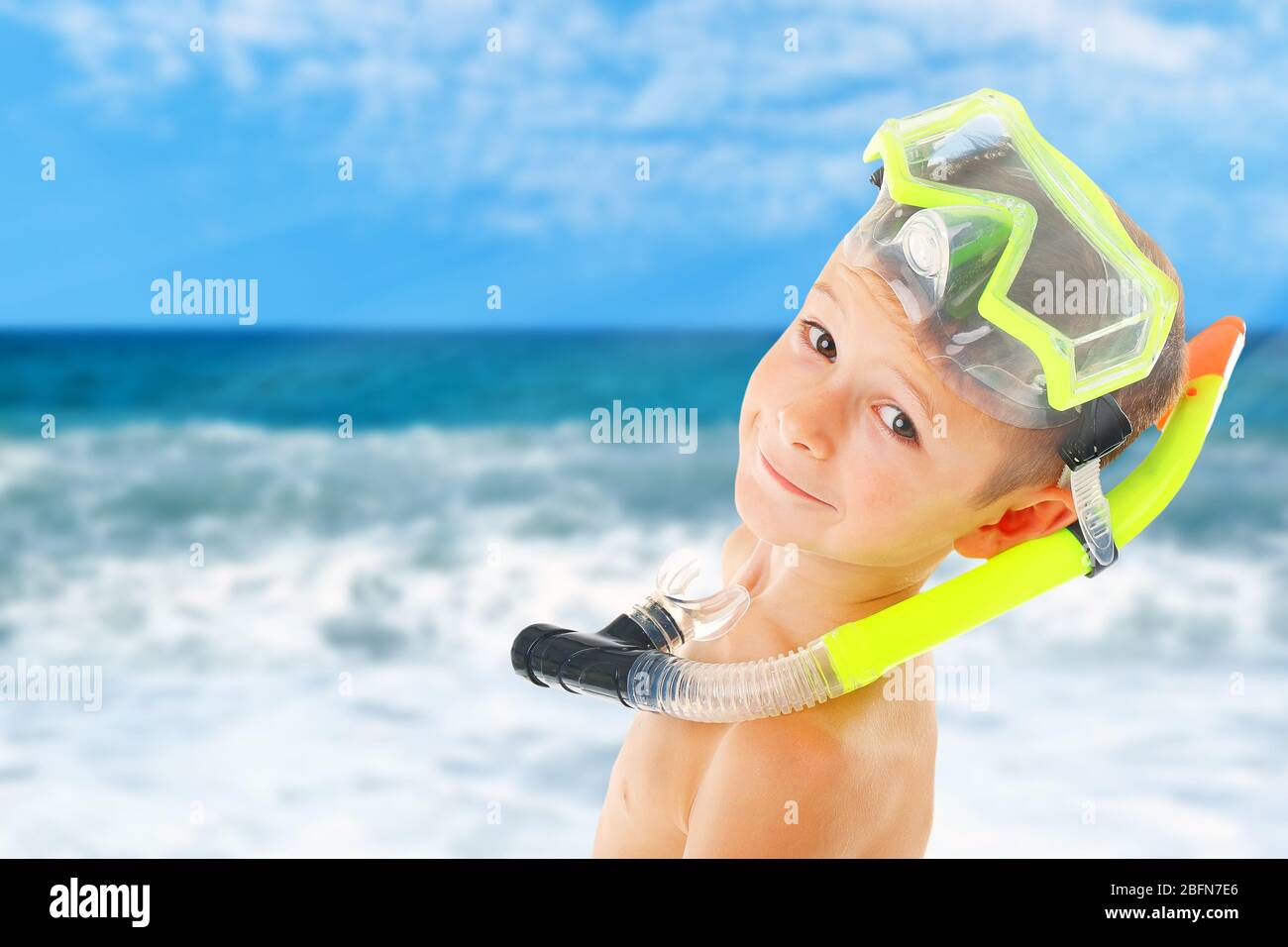 Happy boy with yellow diving mask on blurred sea background Stock Photo ...