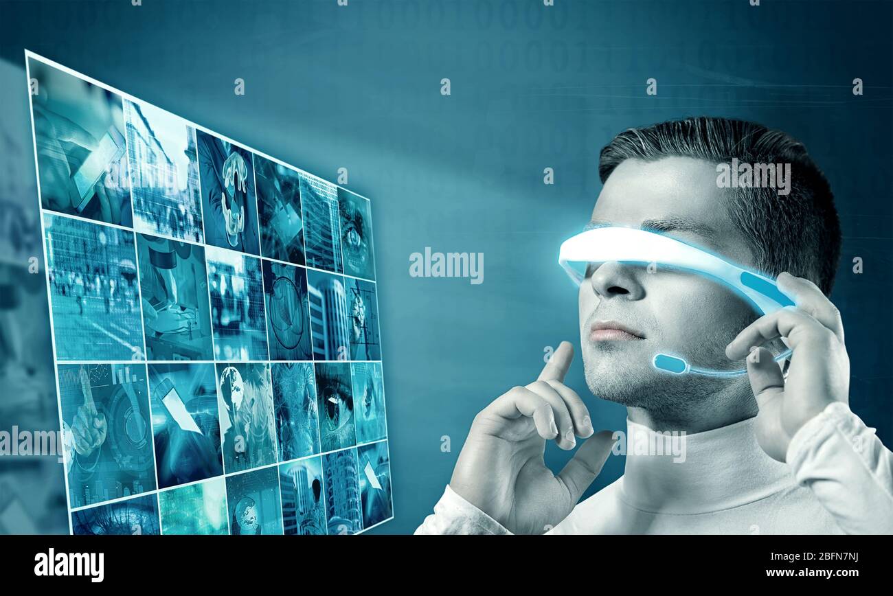 Young man in futuristic glasses. Projection of multimedia images ...