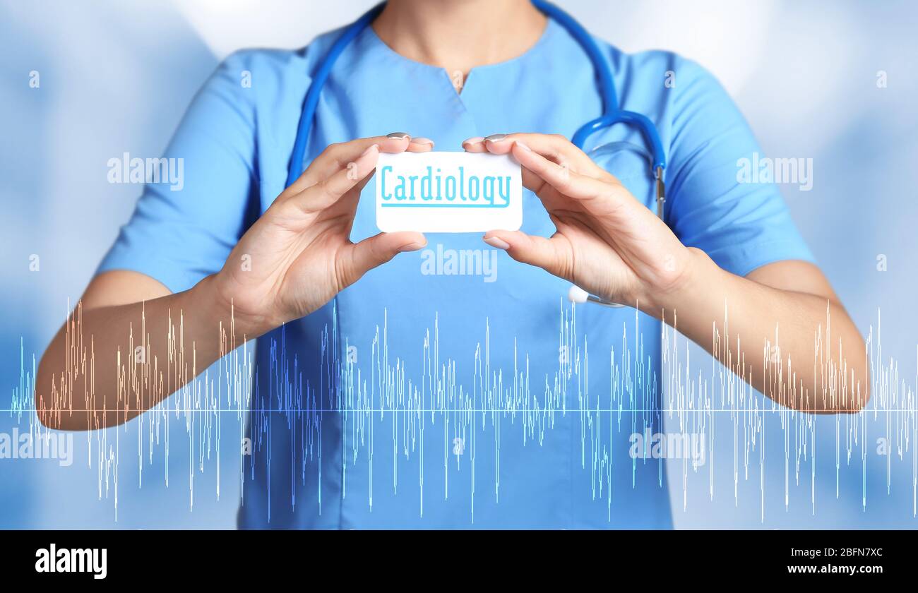 Cardiologist holding business card with word CARDIOLOGY. Heart care ...