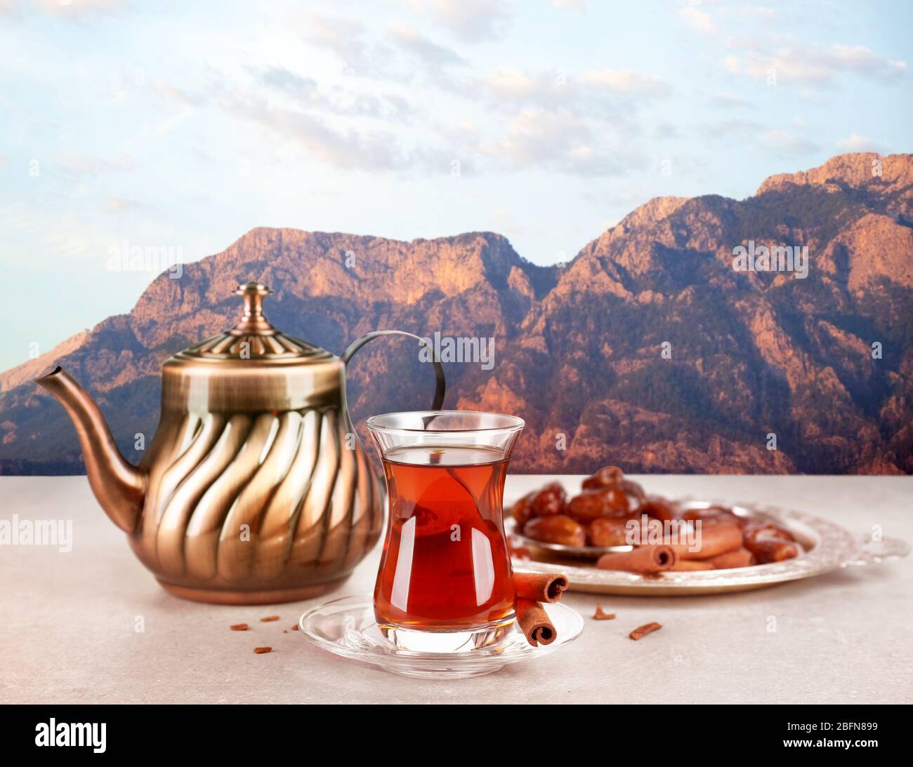 Composition for Turkish tea ceremony on table against landscape ...
