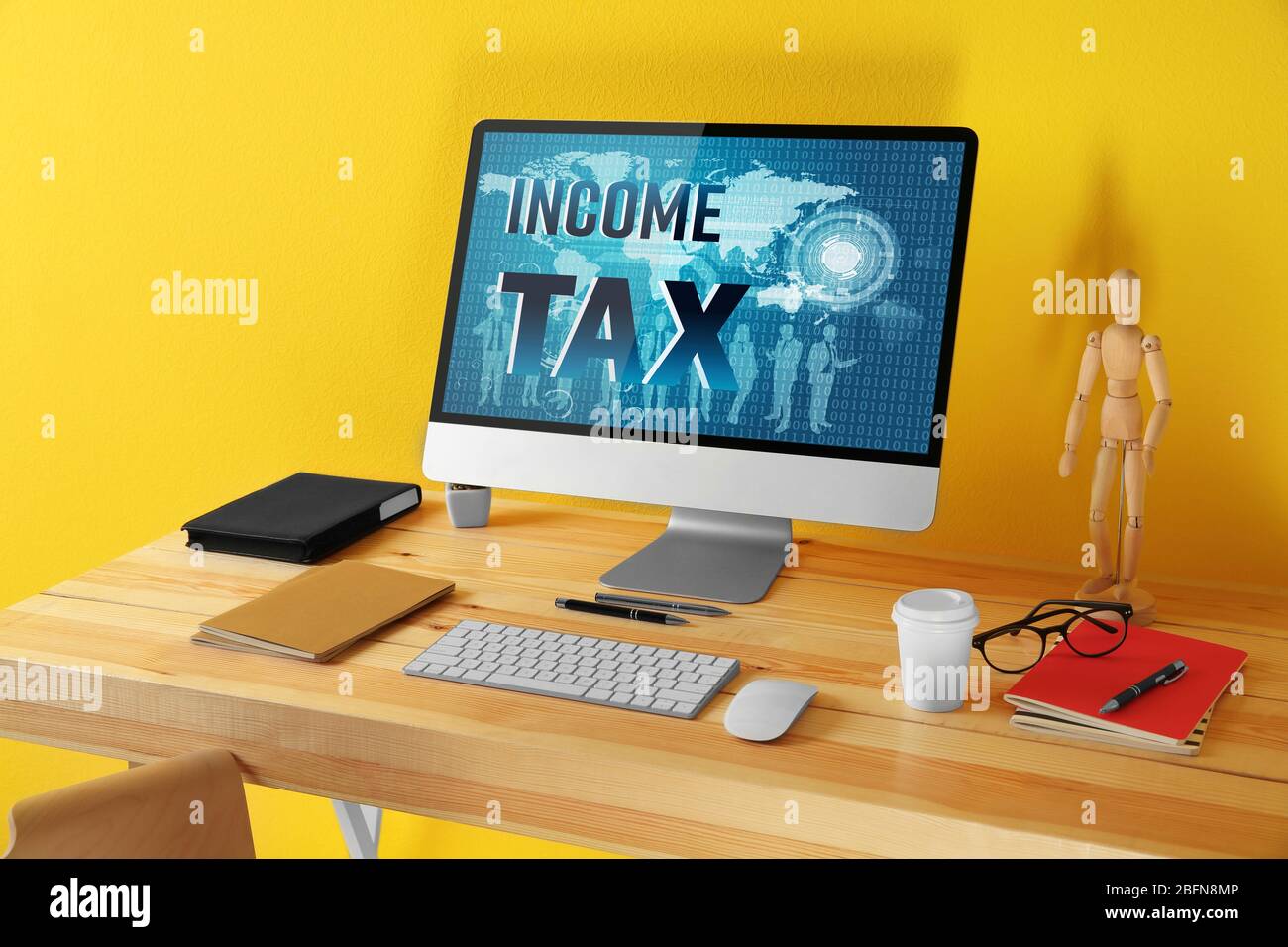 Modern workplace with computer. Text INCOME TAX on screen. Online tax ...