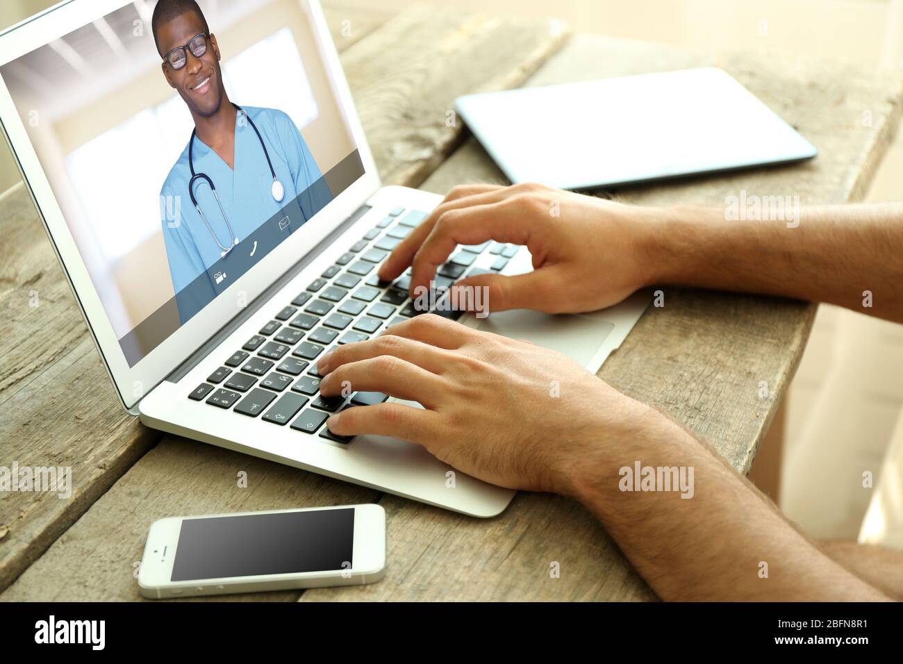 Man video chatting with doctor on laptop. Professional medical online ...