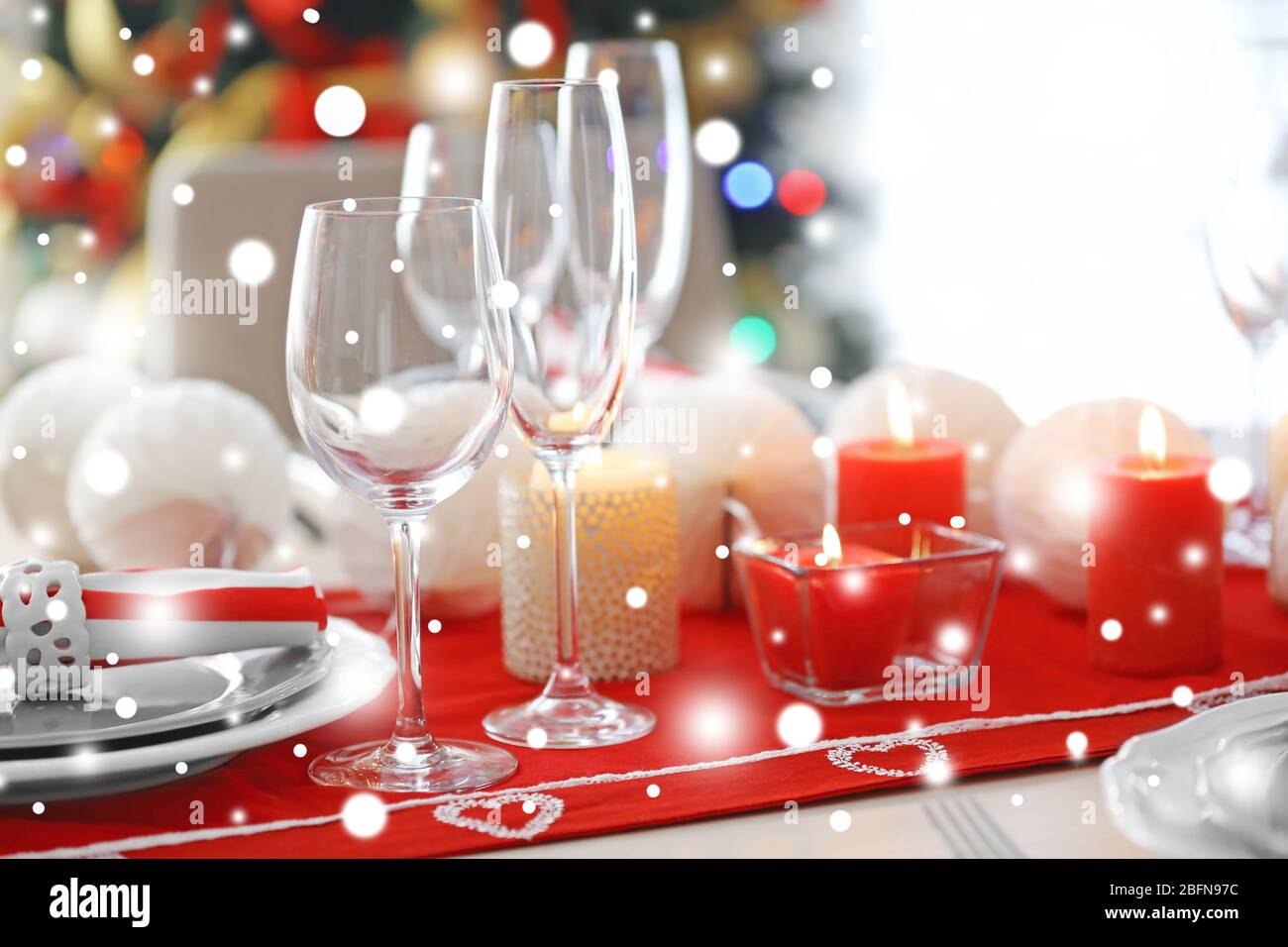 Table setting for festive Christmas dinner, closeup. Snowy effect ...