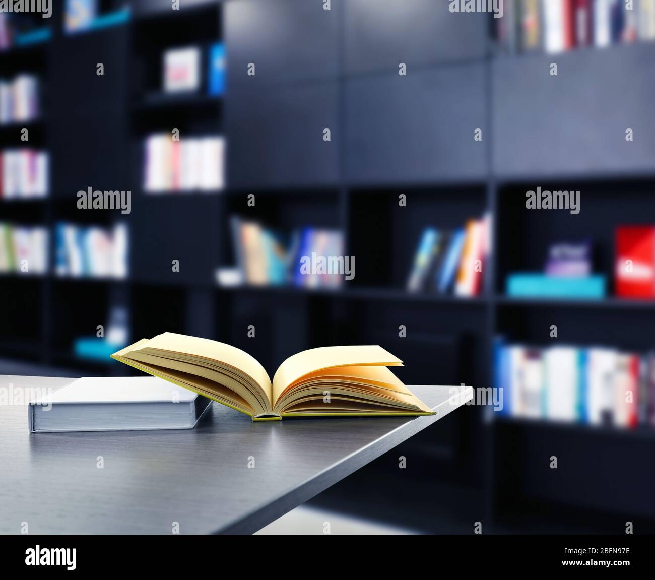 Books on table at library Stock Photo - Alamy
