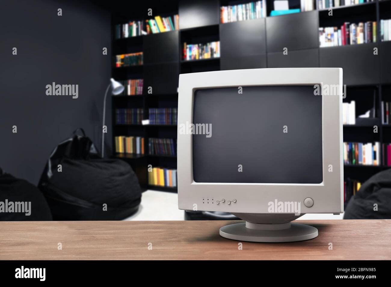 Computer monitor on table at library Stock Photo - Alamy