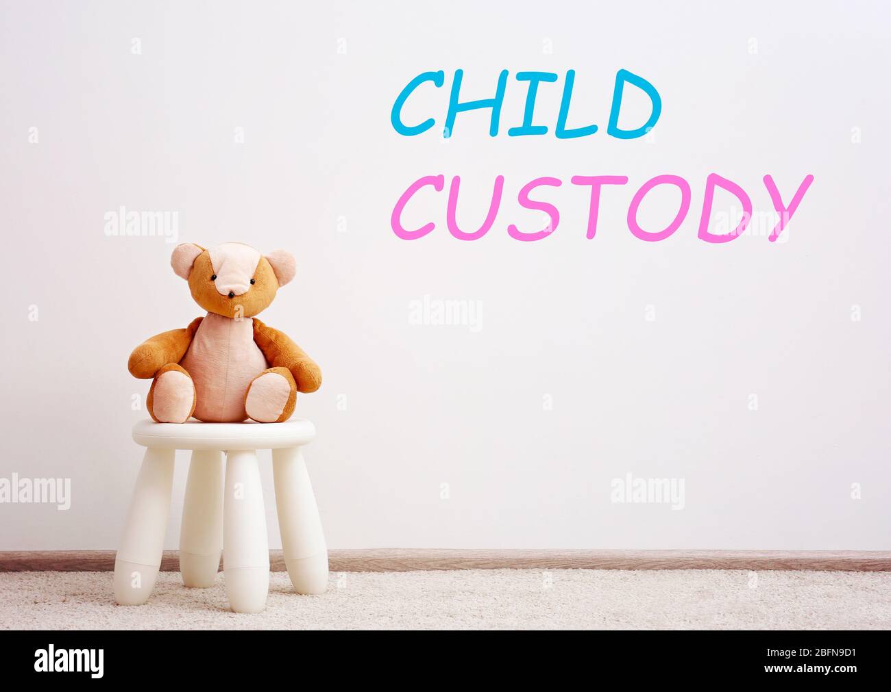 Children stool with toy. Text CHILD CUSTODY on wall background Stock ...