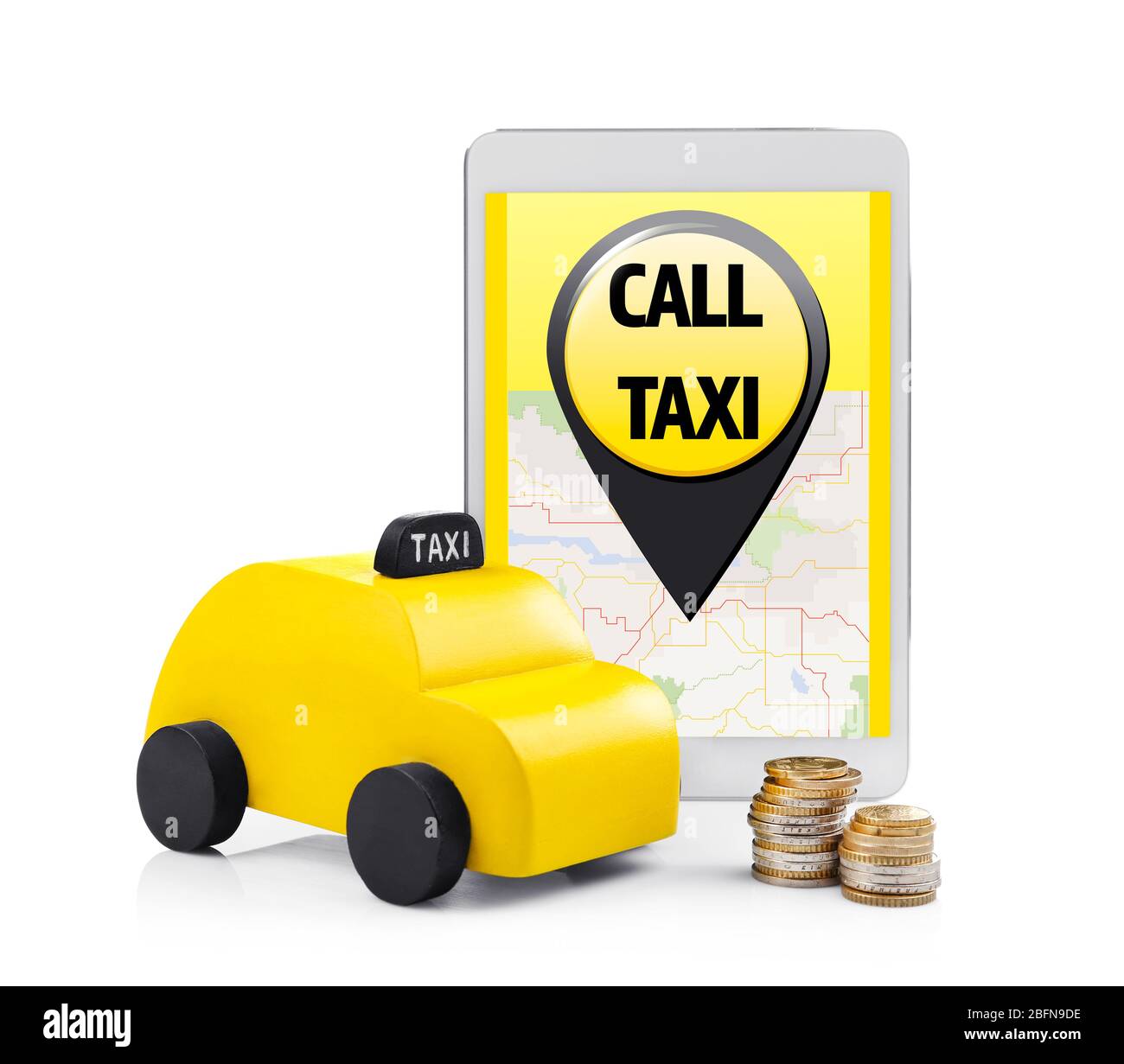 Yellow toy taxi cab, tablet and coins on white background. Taxi service ...