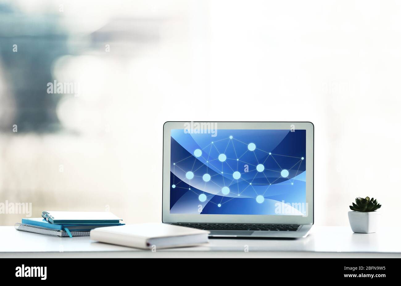 Modern workplace with laptop. Network design on screen Stock Photo - Alamy