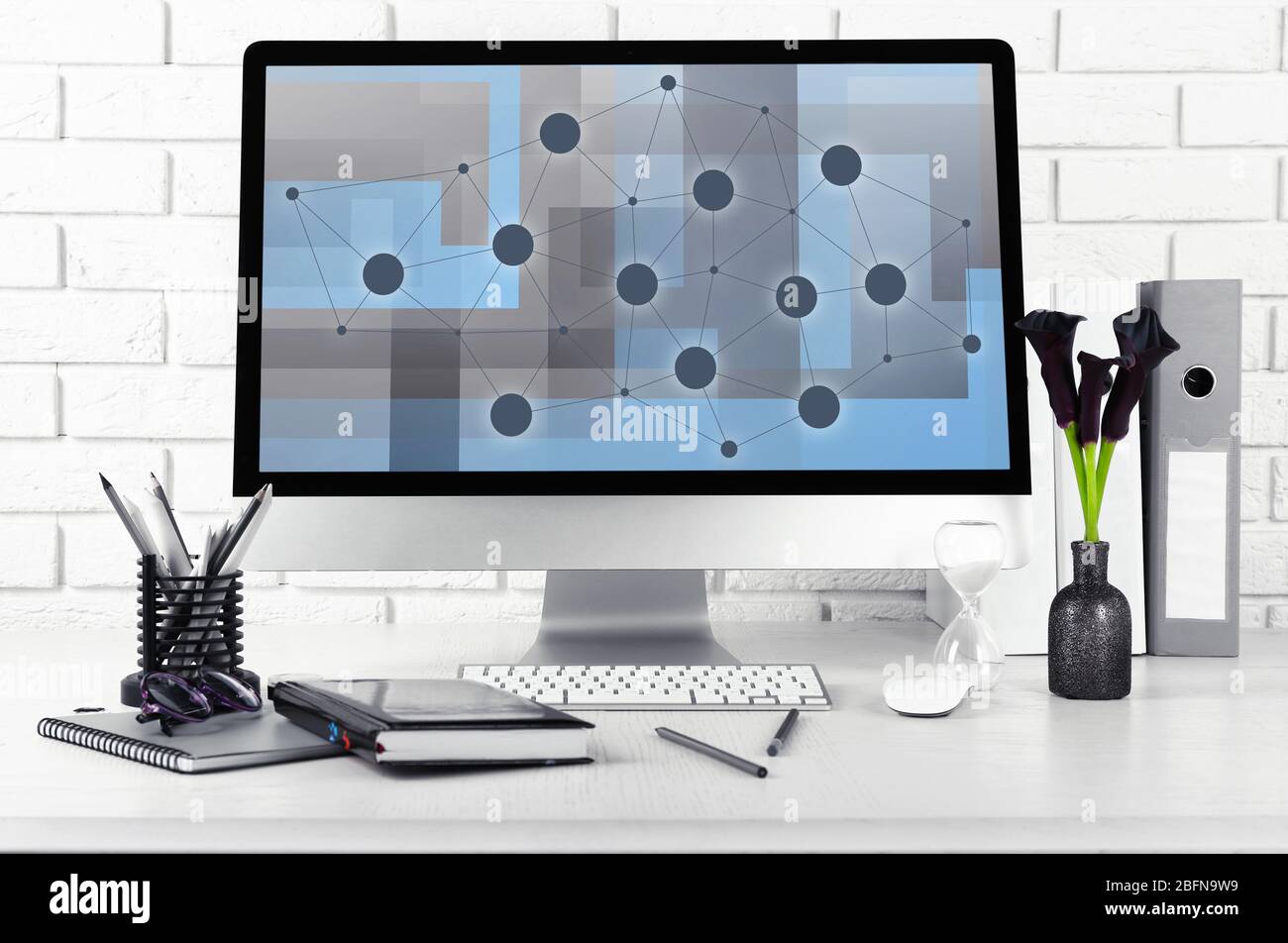 Modern workplace with computer. Network design on screen Stock Photo ...