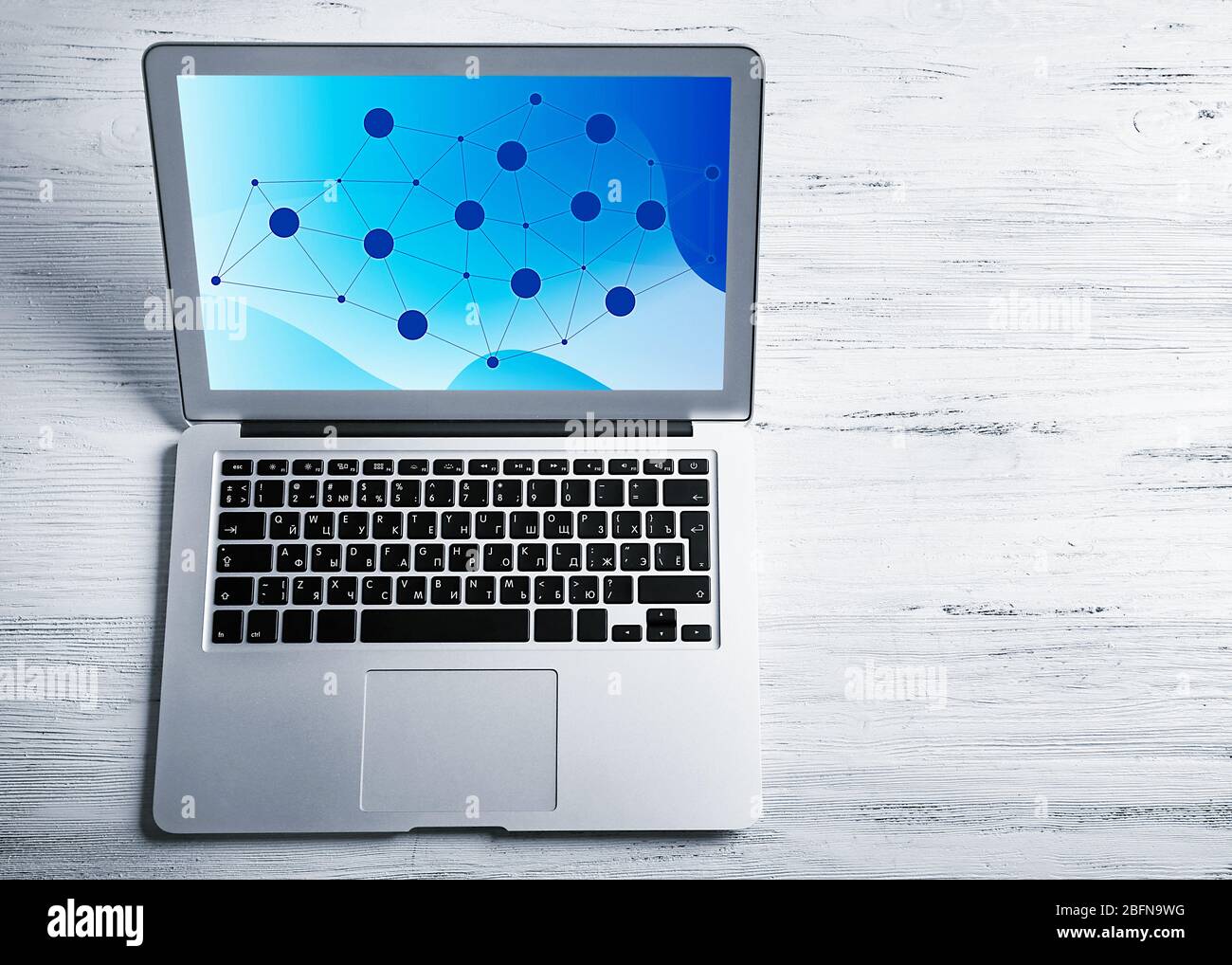 Laptop on white wooden background. Network design on screen Stock Photo ...